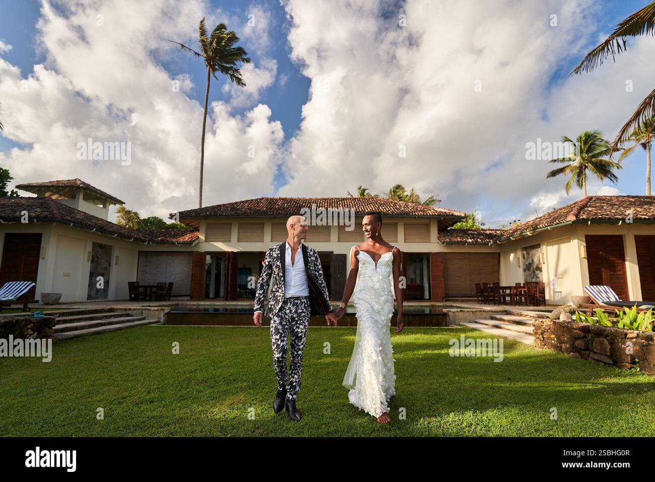 Ambiguous gender fluid person in white bridal dress and lgbtq groom in ...