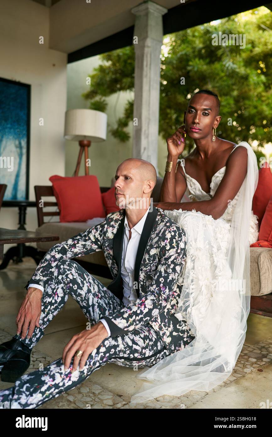 Ambiguous gender fluid person in white bridal dress with LGBTQ partner ...
