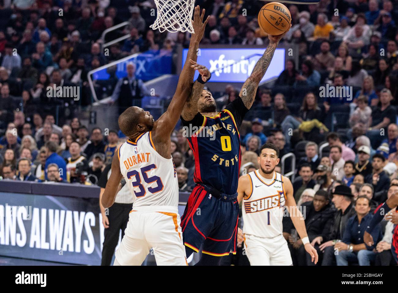 Golden State Warriors guard Gary Payton II (0) drives against Phoenix Suns forward Kevin Durant ...