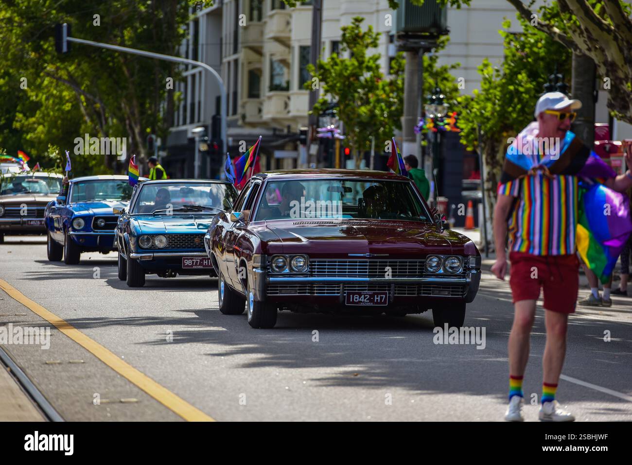 A group of classic cars are seen driving in the Pride parade 2025, part ...