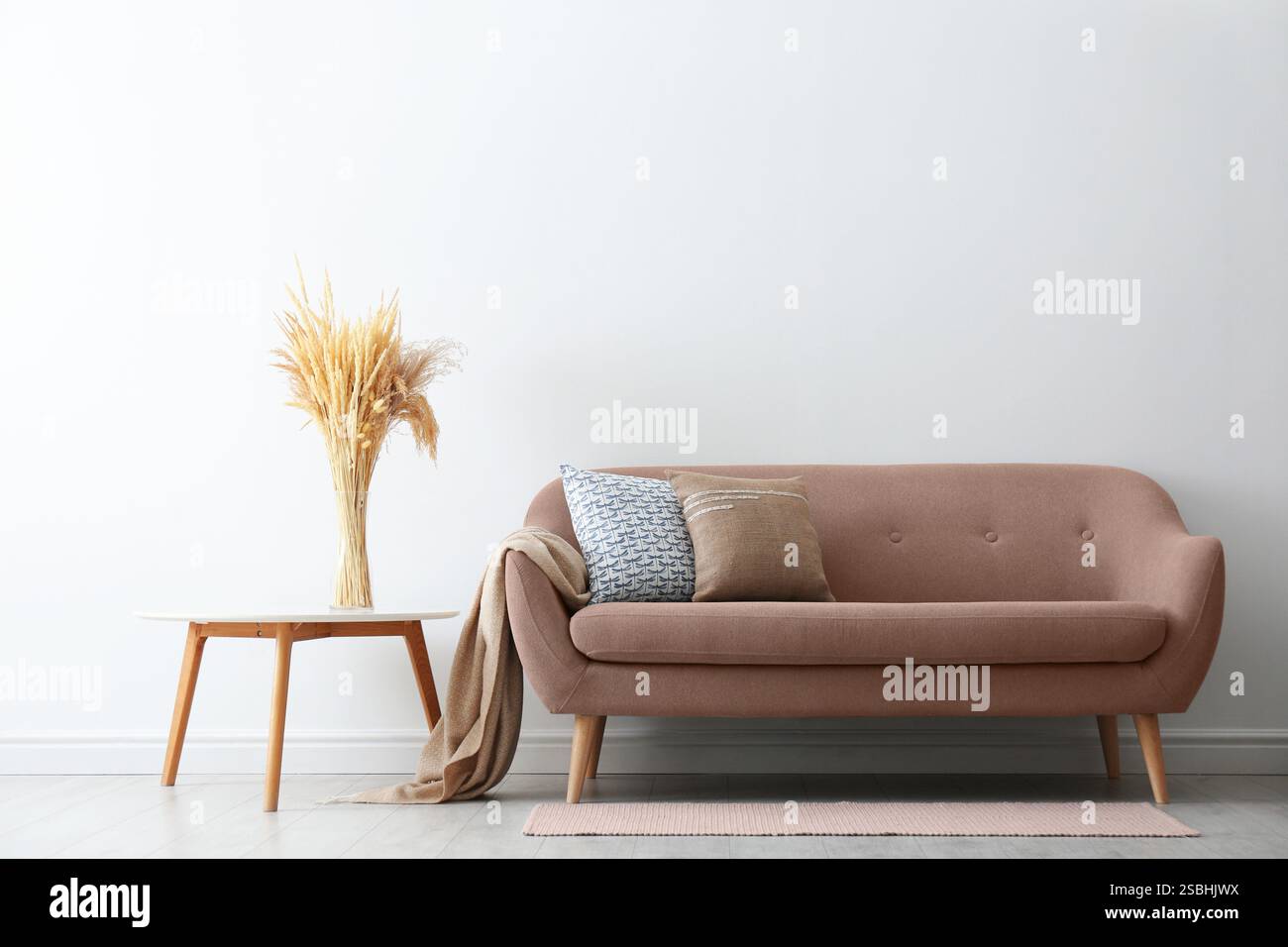 Sofa in mocha mousse shade and decor indoors. Interior with trendy ...