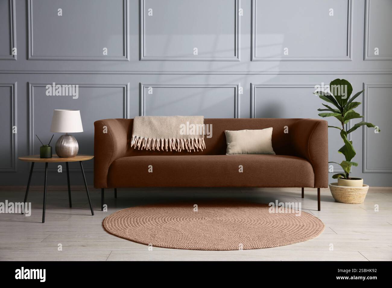 Sofa in mocha mousse shade indoors. Cozy interior with trendy color of 2025 year Stock Photo - Alamy