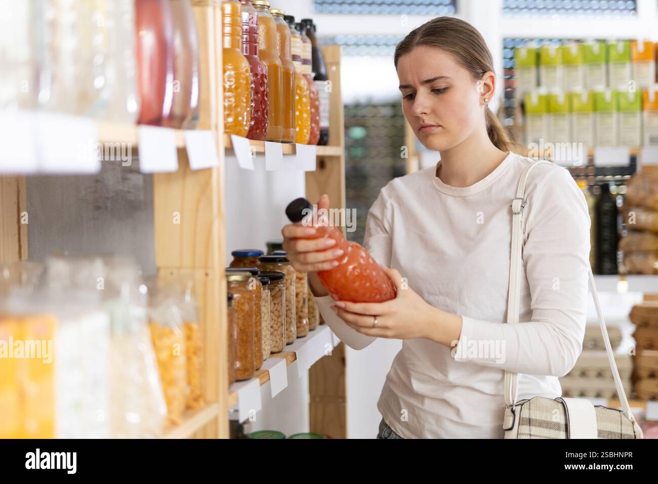Customer chooses juice in a bottle Stock Photo - Alamy