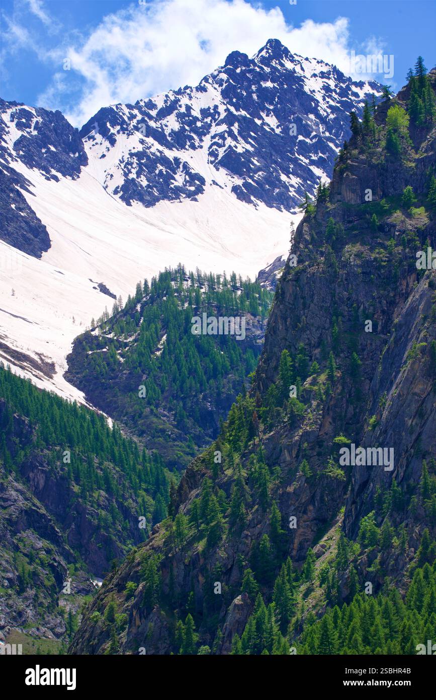 Snow on the upper slopes of mountains surrounding the Vallouise valley ...