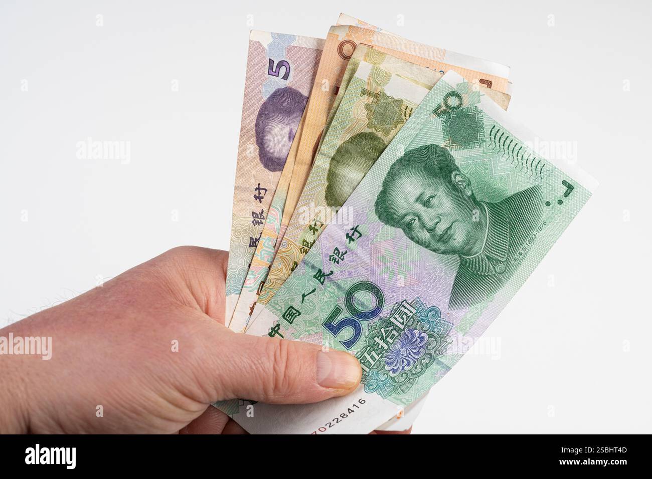 Some chinese Renminbi banknotes in the hand Stock Photo - Alamy