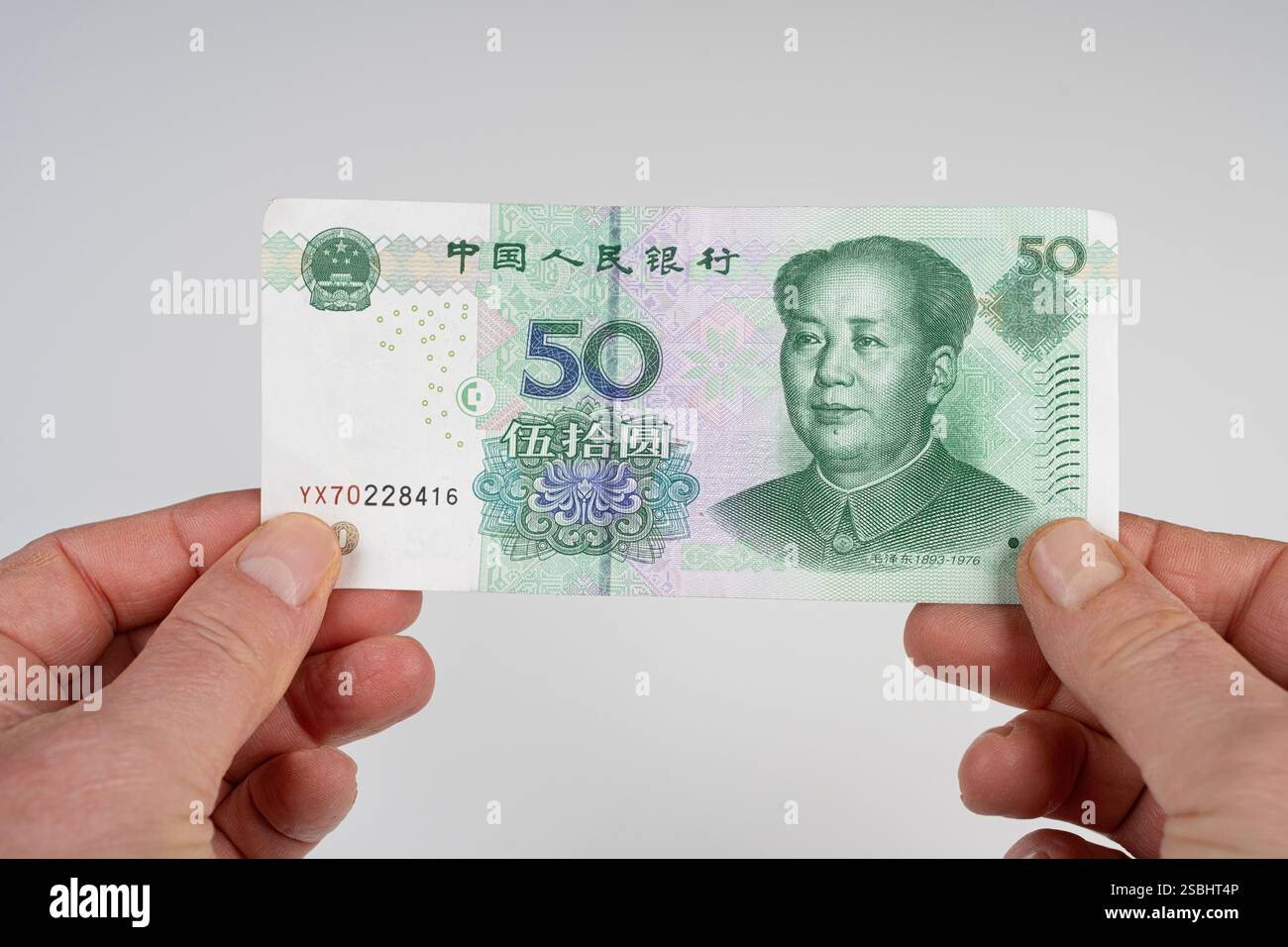 A 50 Yuan banknote in the hand Stock Photo - Alamy