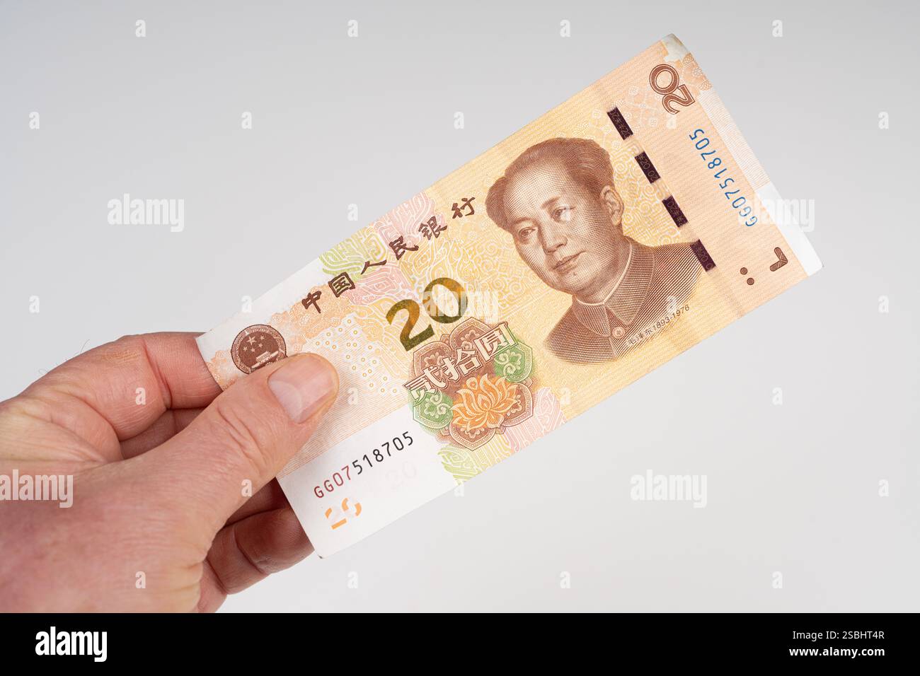 A 20 Yuan banknote in the hand Stock Photo - Alamy