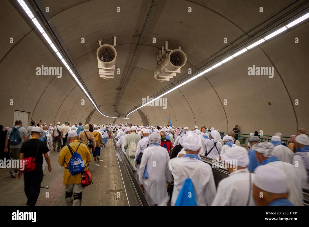 Mecca, Saudi Arabia - June 18, 2024: Pilgrims walking in a tunnel towards the Jamarat stoning ...