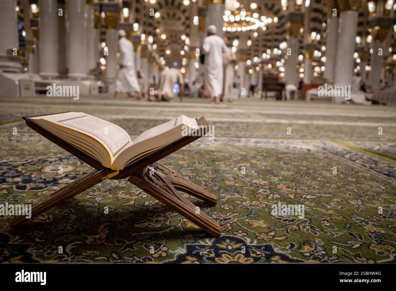 The holy book of the Quran is opened on a green carpet at the Prophet ...