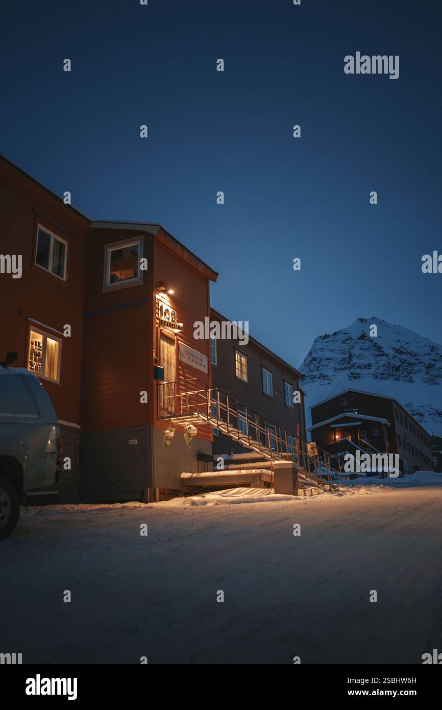 Illuminated entrance to Gjestehuset Hostel in the polar night in ...