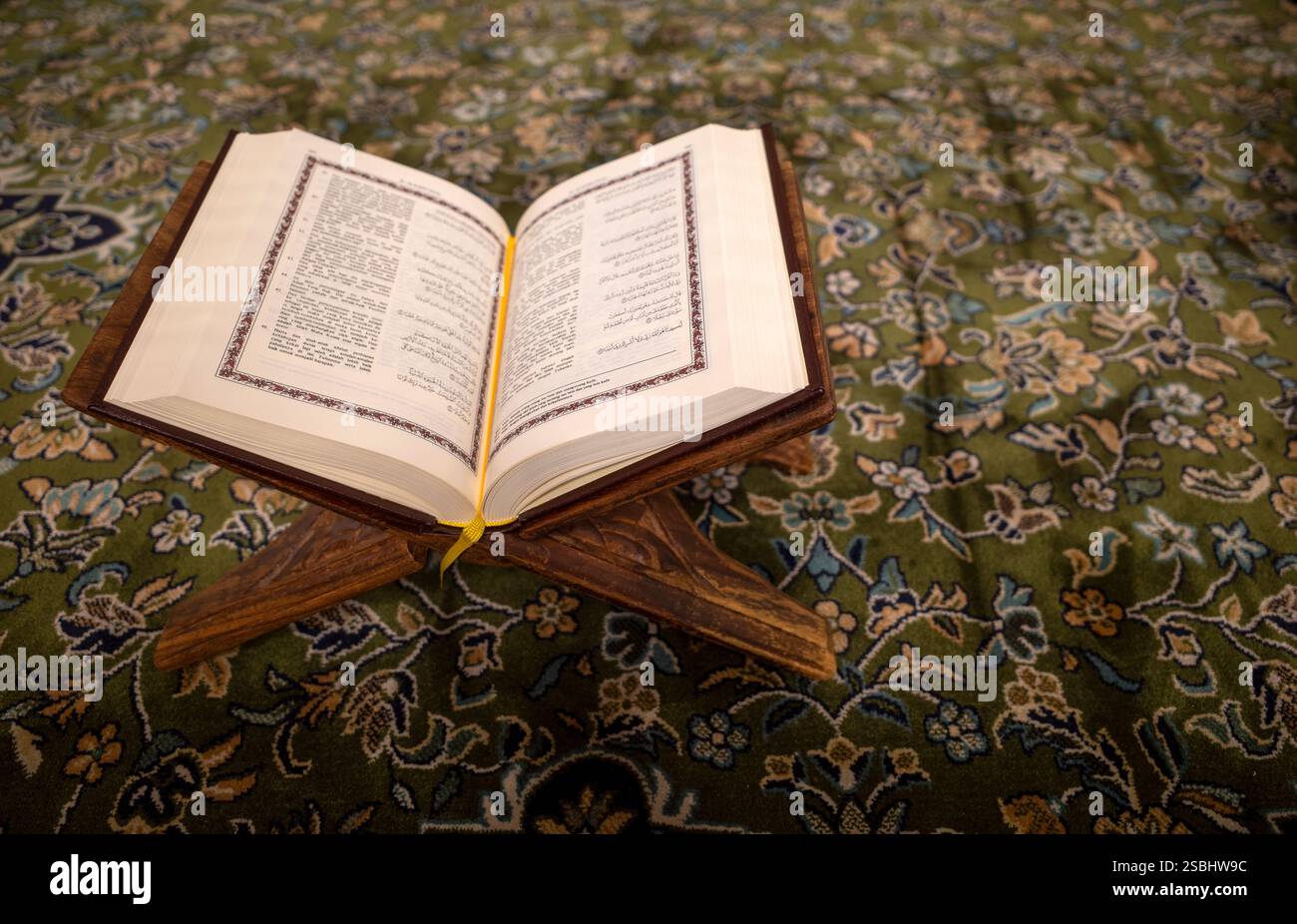 The holy book of the Quran is opened on a green carpet at the Prophet ...