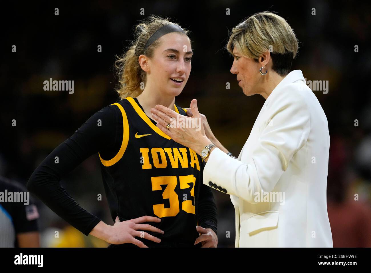 Iowa head coach Jan Jensen talks with guard Lucy Olsen (33) during the ...