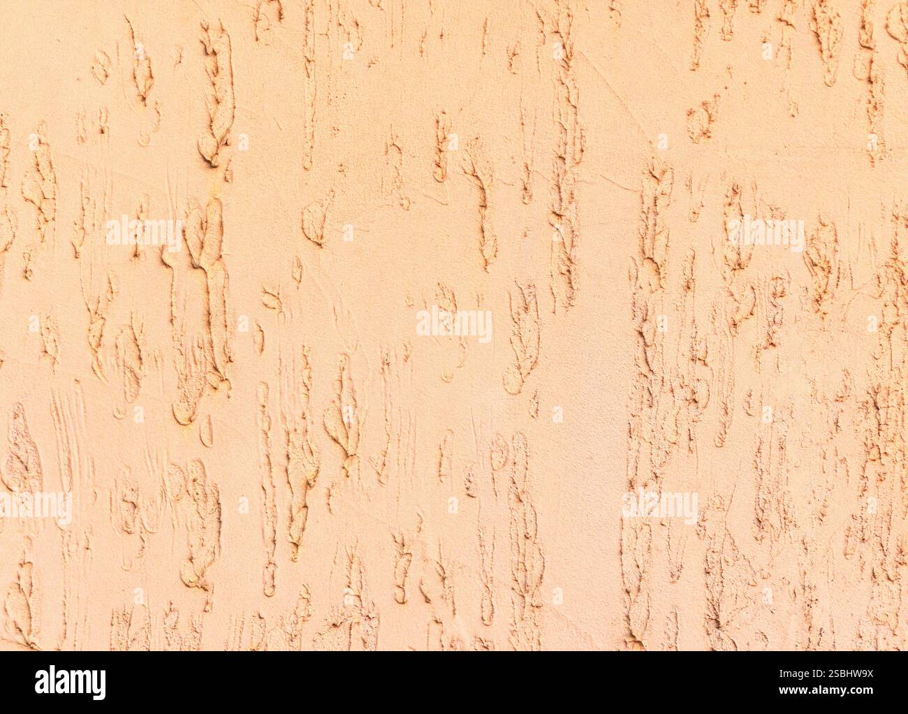 Decorative plaster of peach color, with random strokes in the wall ...