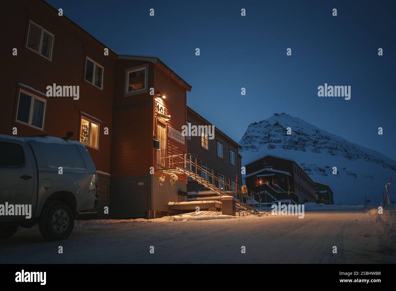 Lit up hostel entrance in Nybyen in winter in Longyearbyen, Svalbard ...
