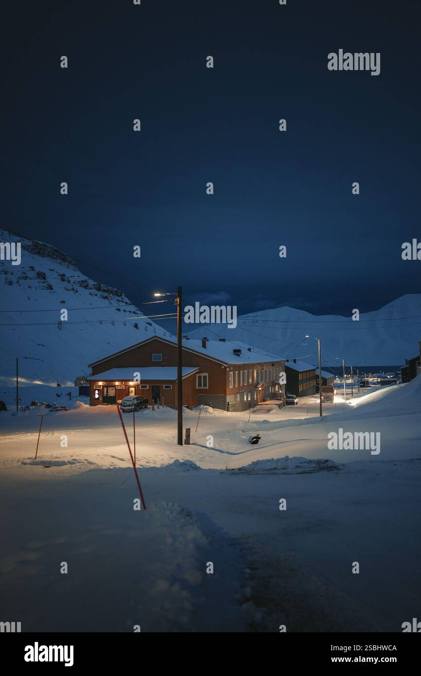 Buildings by snowy road in Nybyen in winter in Longyearbyen, Svalbard ...