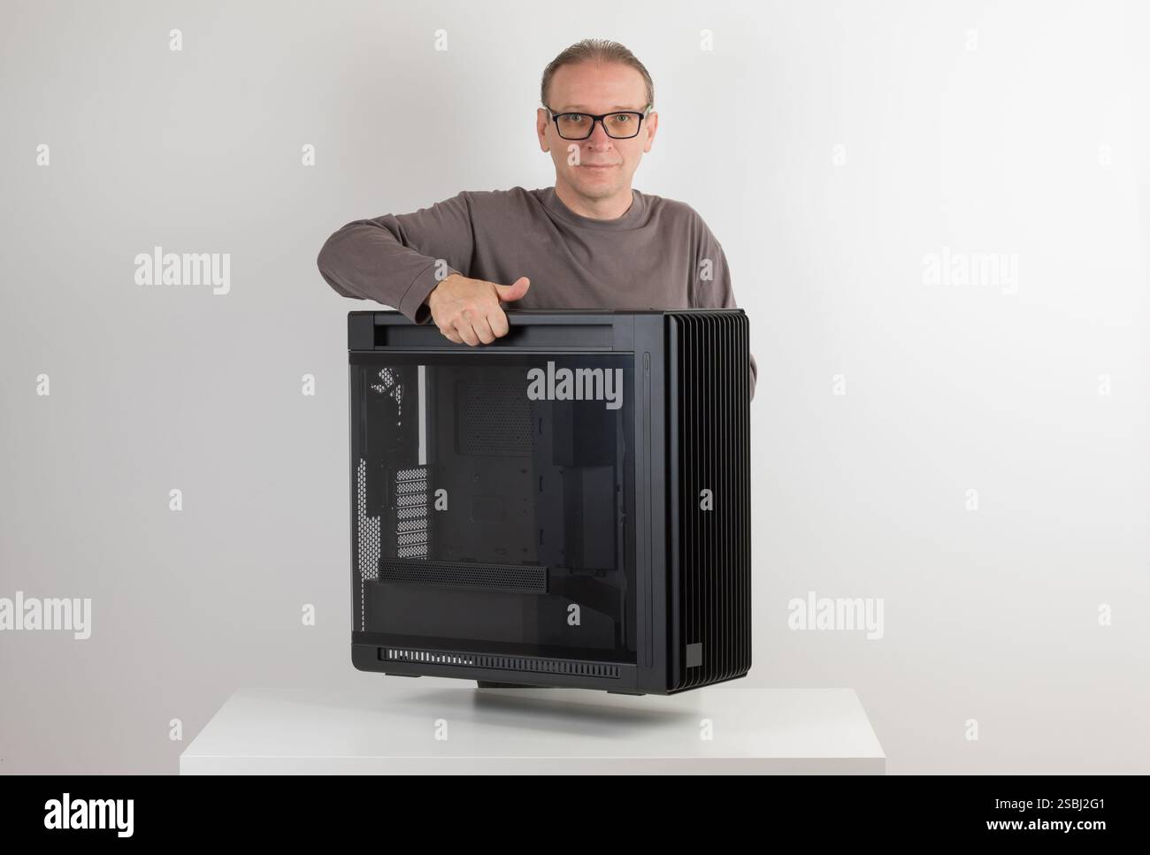 Man holding a heavy PC case, weight 15,8 kg, empty big tower, chassis ...