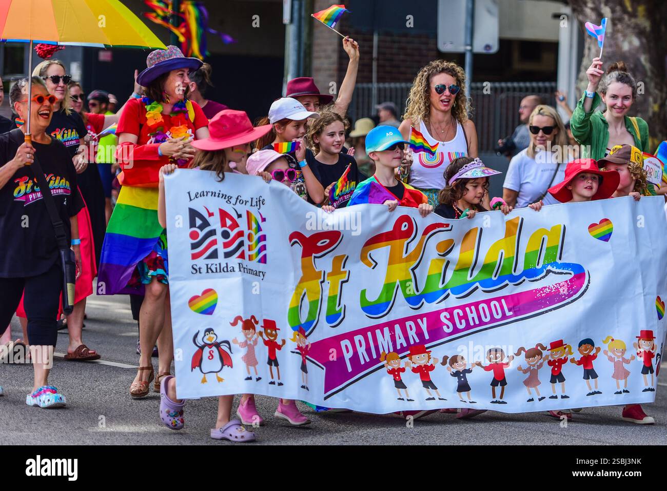 Primary school students and their parents are seen marching in the ...