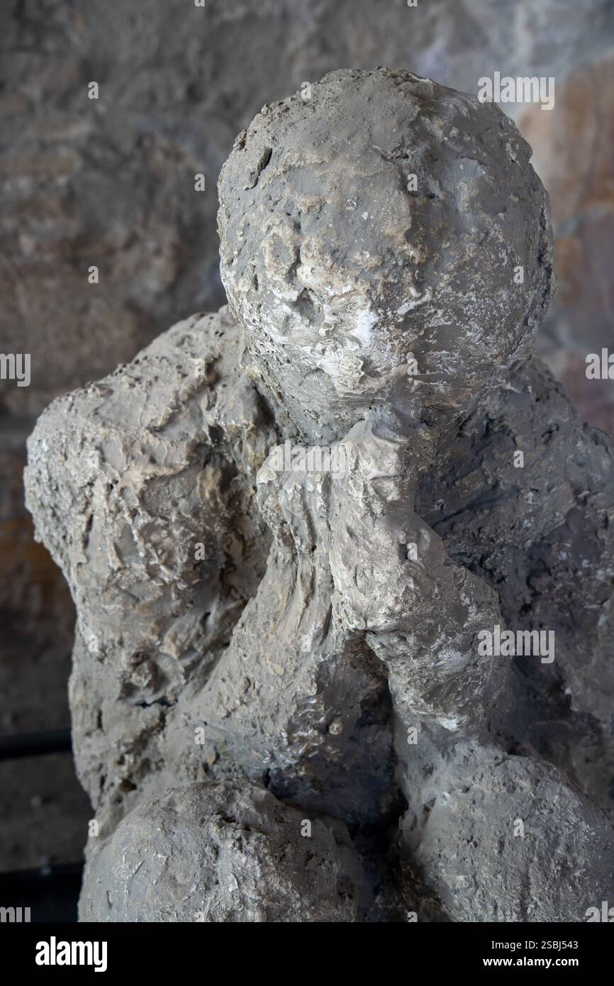 Plaster cast of a victim of the volcanic eruption, displayed in the Macellum in the ancient ...