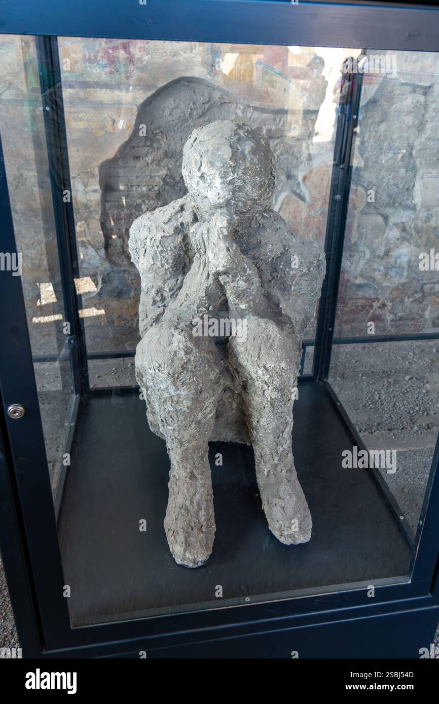 Plaster cast of a victim of the volcanic eruption, displayed in the ...