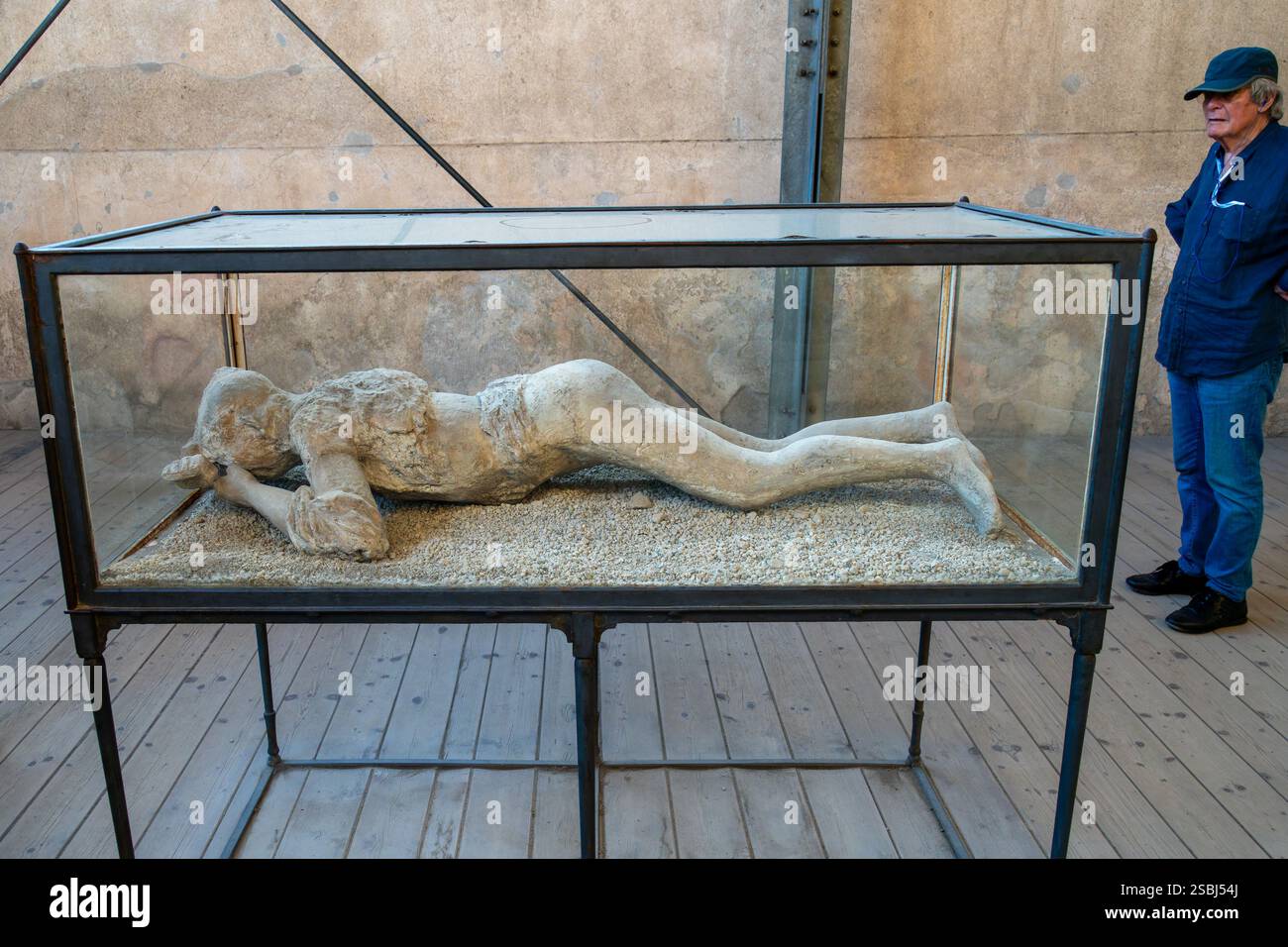 Plaster cast of a victim of the volcanic eruption, displayed in the Macellum in the ancient ...