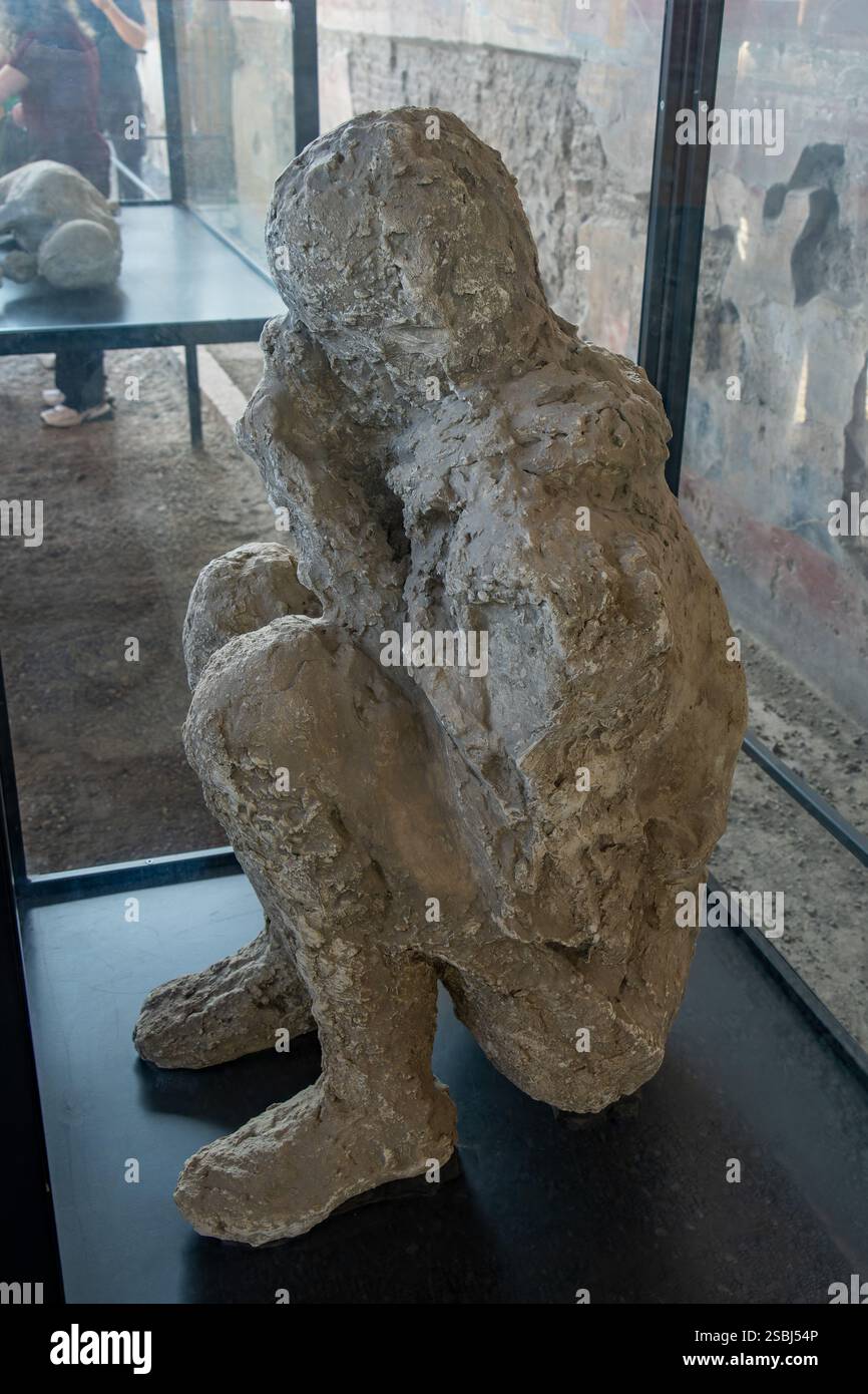 Plaster cast of a victim of the volcanic eruption, displayed in the ...