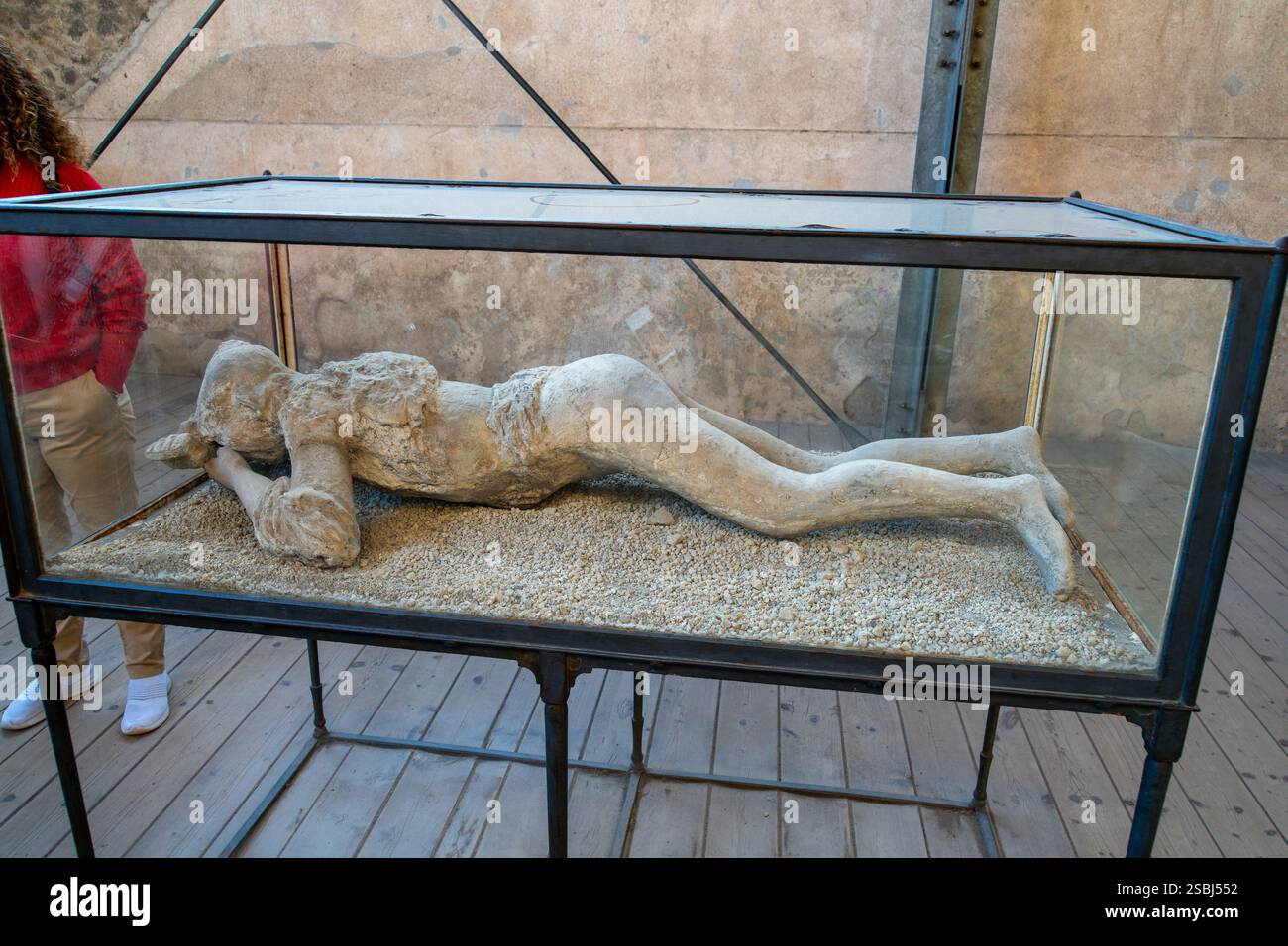Plaster cast of a victim of the volcanic eruption, displayed in the Macellum in the ancient ...