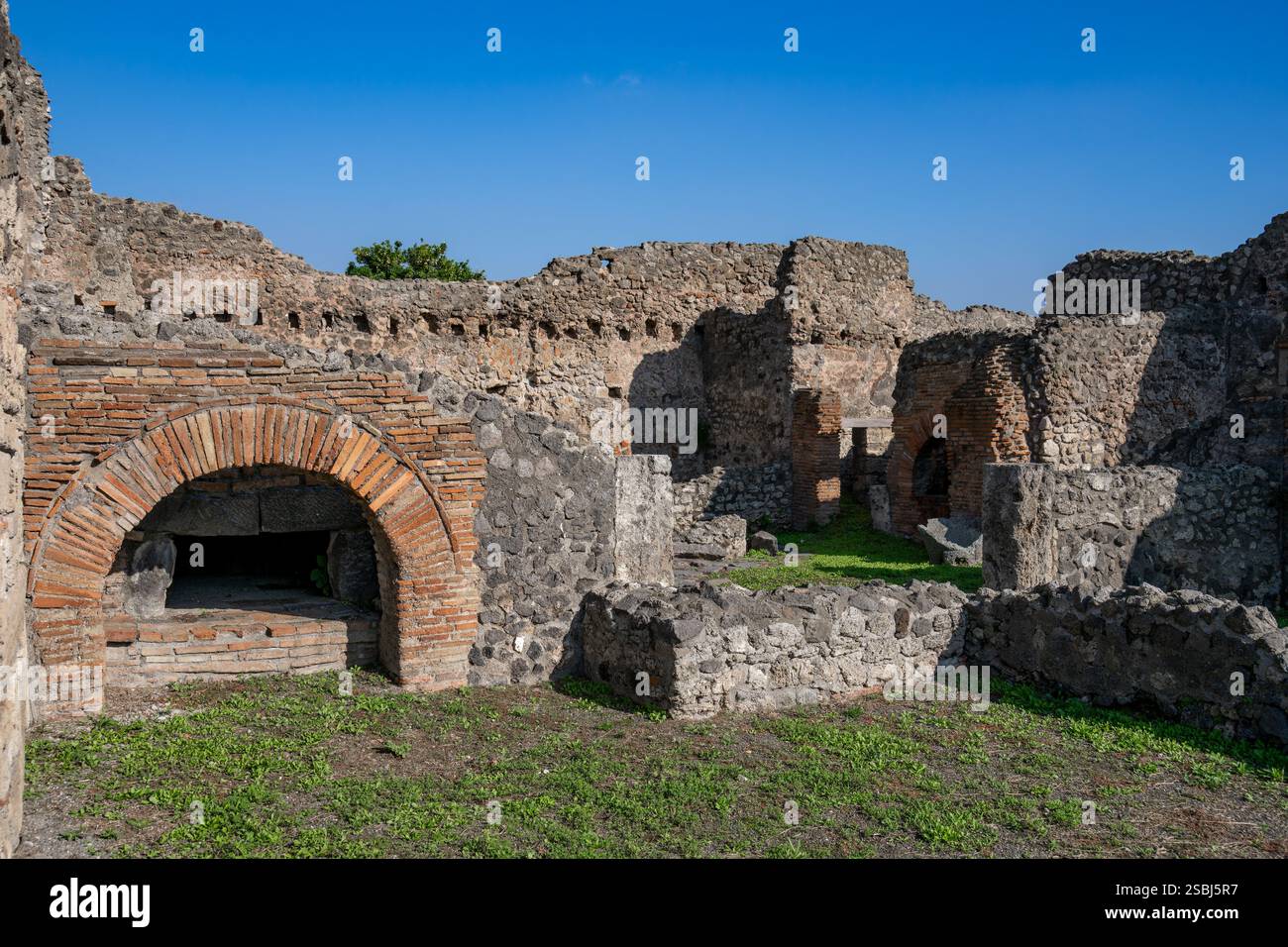 Ruins of a pastry bakery, Building I.14.3, in the ancient Roman ruins ...