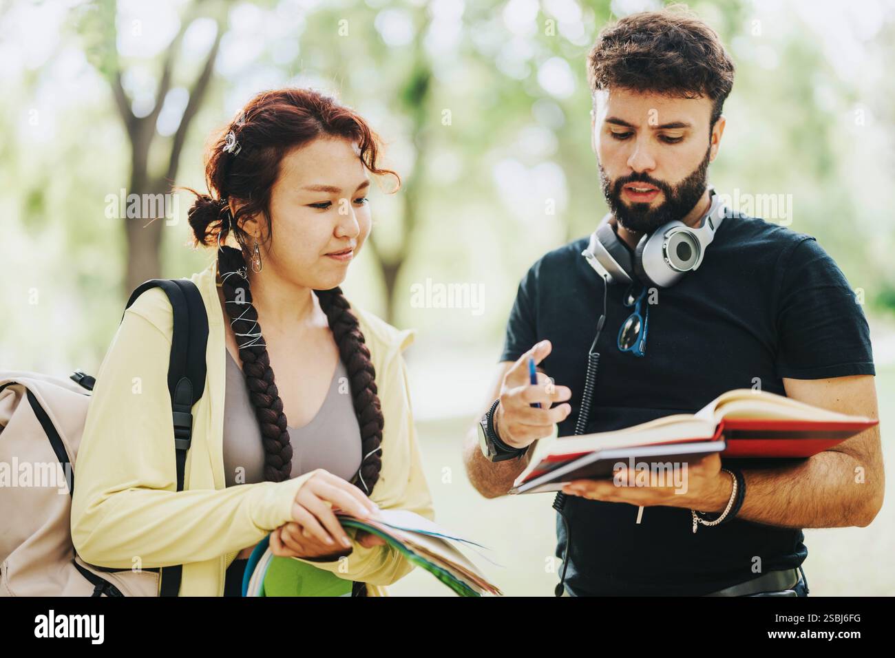 Students consulting professor in a park setting after class Stock Photo ...