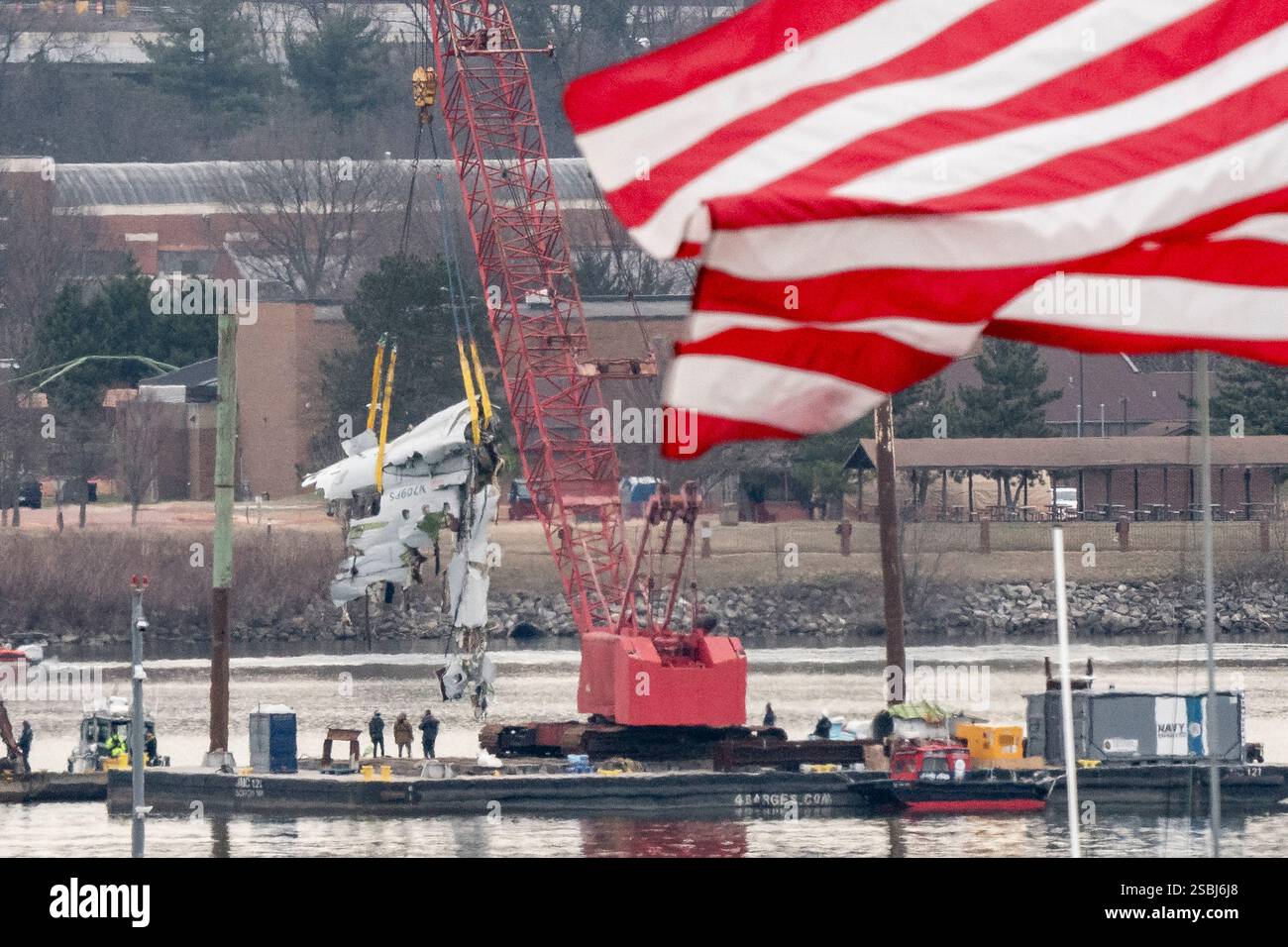Recovery salvage experts lift the fuselage of the American Eagle ...