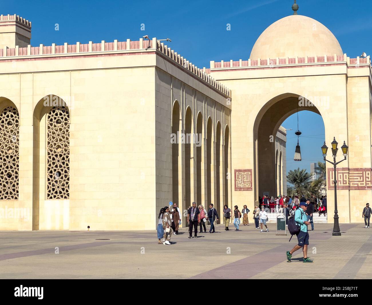Manama, Bahrain - January 5, 2025: Visitors walk near the entrance of ...