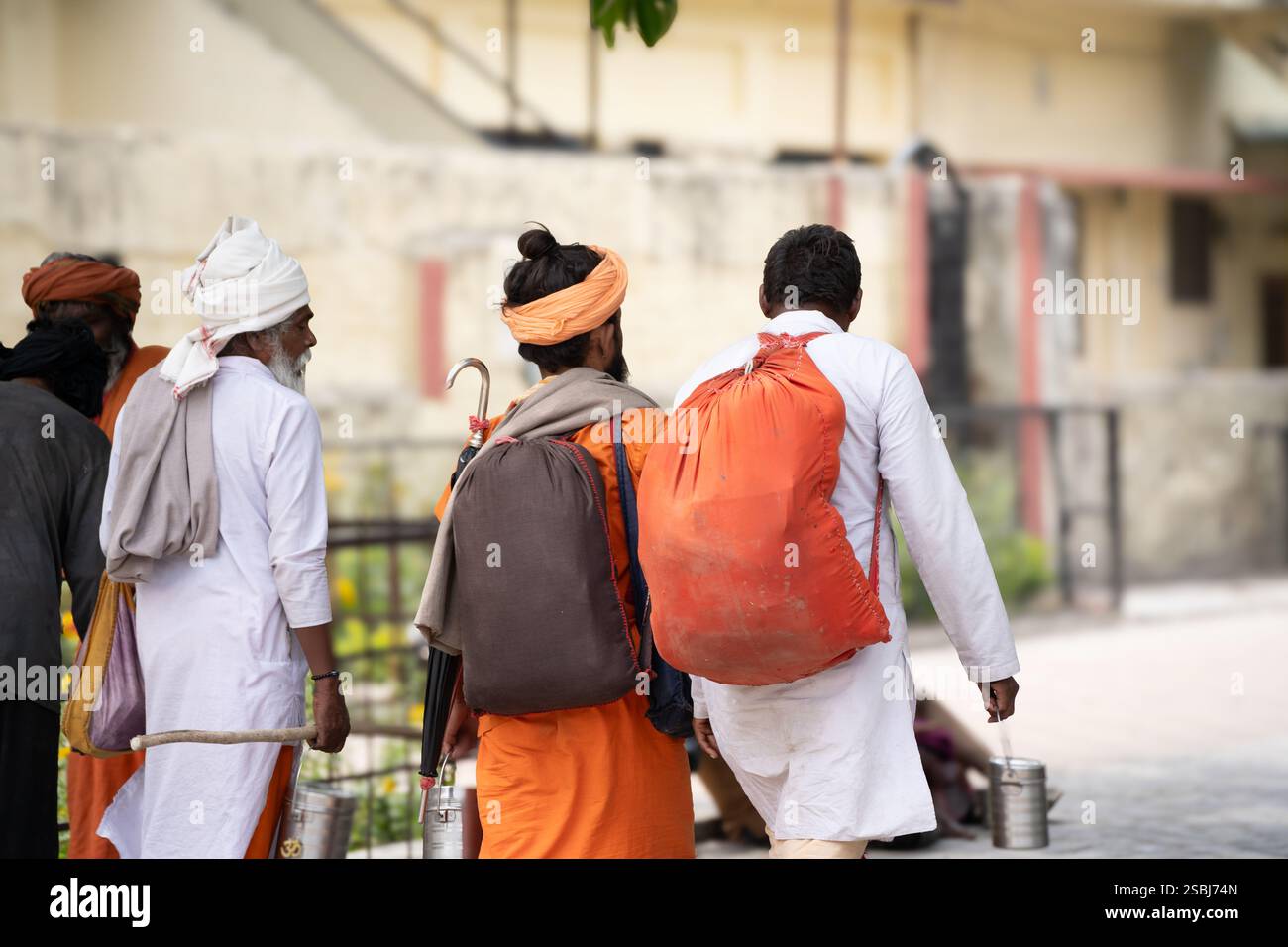 Group of hindu religious sadhu priest holy men walking with bags to the ...