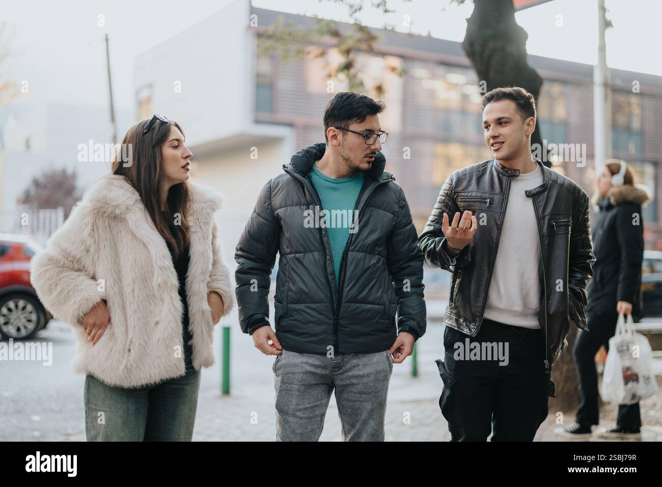 Group of friends walking and talking casually on a street in urban ...