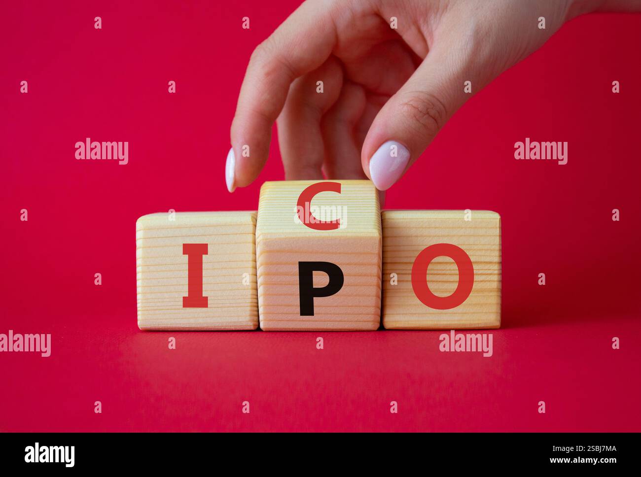 ICO and IPO symbol. Businessman hand turns wooden cubes with words ICO ...