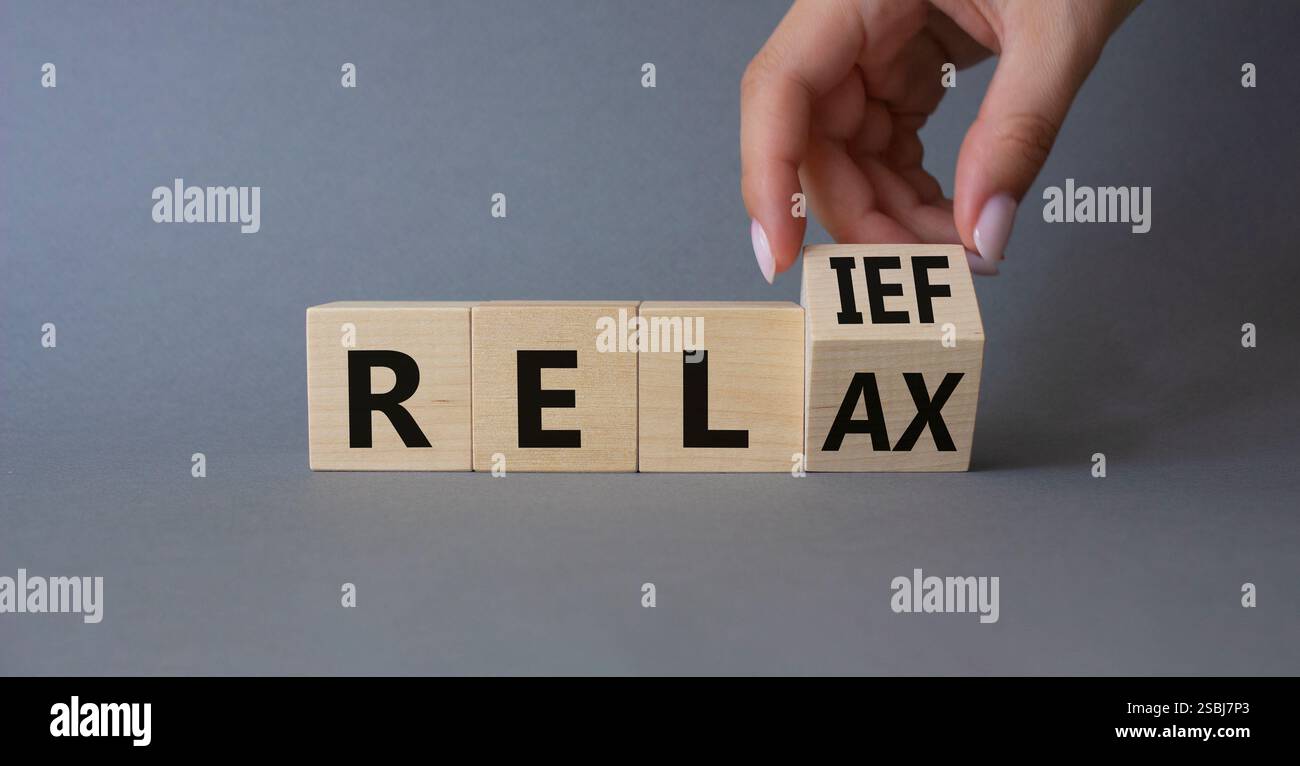 Relief and relax symbol. Hand turns cubes and changes the word Relief ...