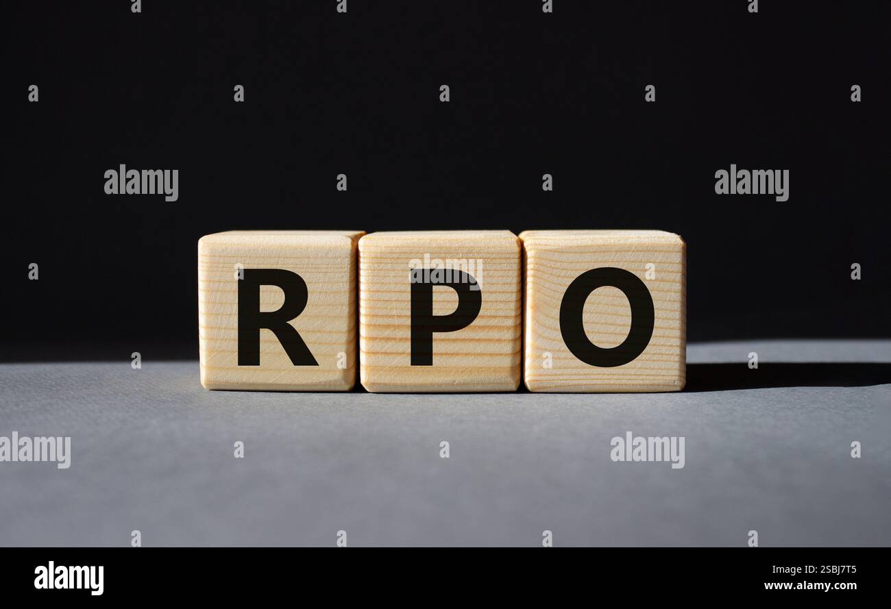 RPO - Recruitment Process Outsourcing symbol. Wooden cubes with words ...