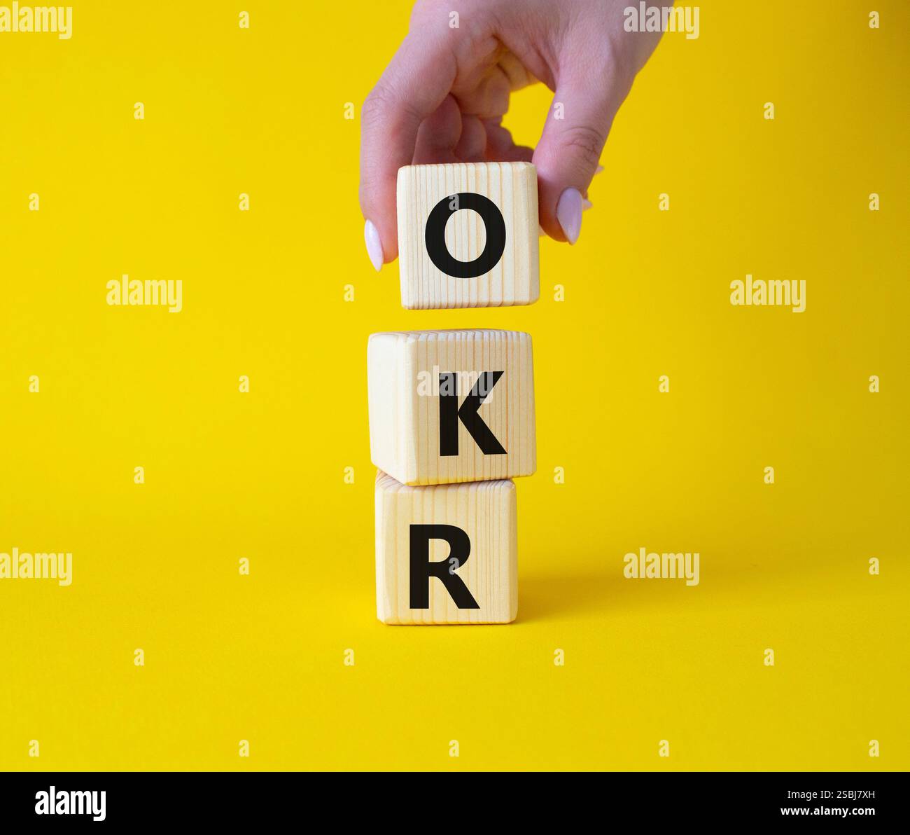 OKR objectives and key results symbol. Wooden cubes with words OKR ...