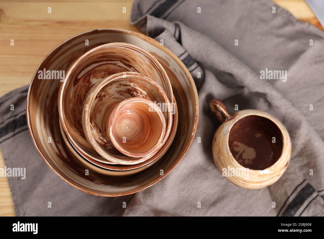 Different beautiful pottery on wooden table, top view Stock Photo - Alamy