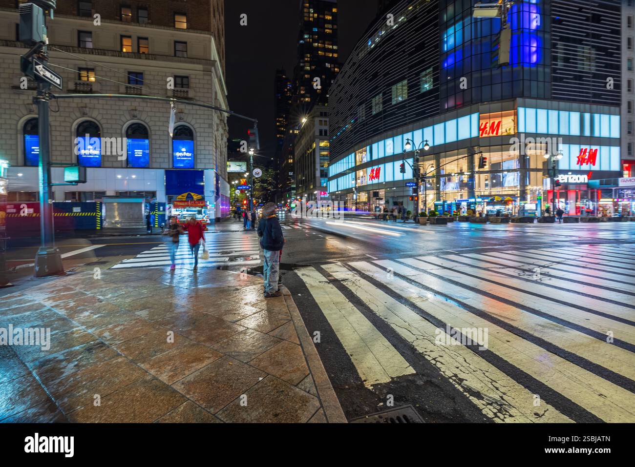 Night scene at busy intersection in New York City with motion blur from ...