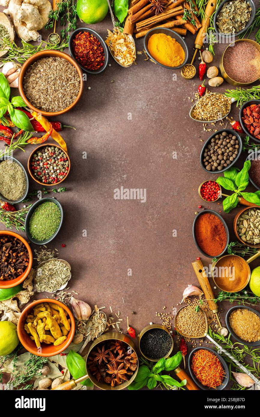 A colorful assortment of fragrant herbs and spices on a warm brown ...
