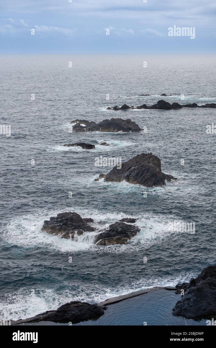 Calm water of partly natural swimming pool and structure of the waves ...