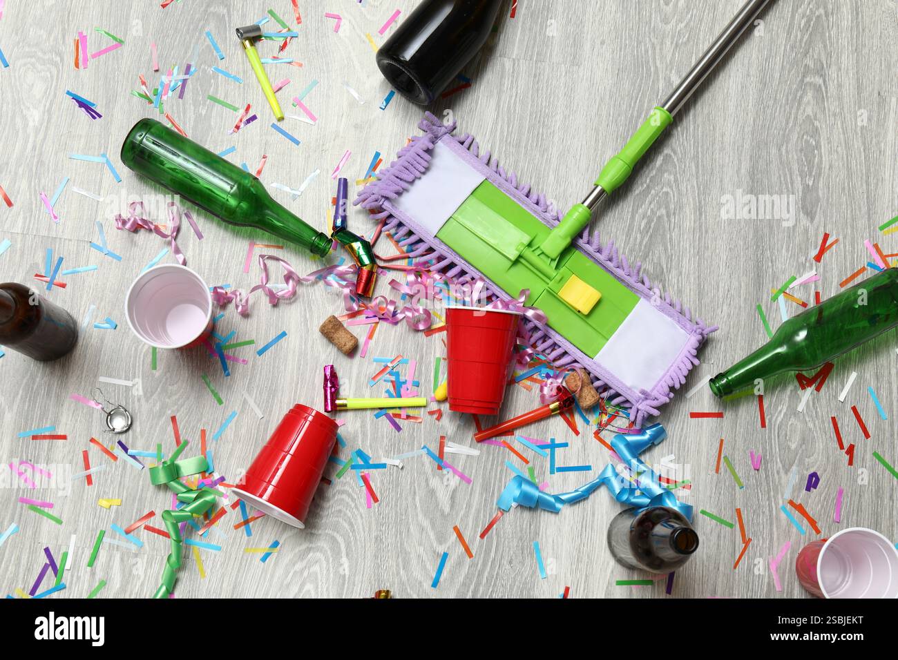 Mop with mess on light wooden floor after party, top view Stock Photo ...