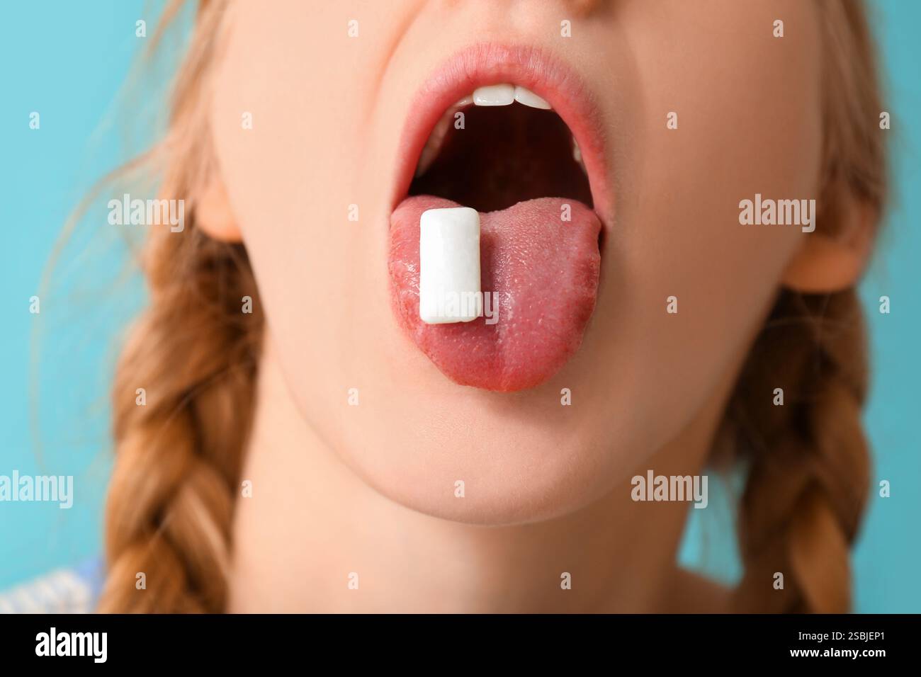 Teenage girl with chewing gum on blue background, closeup Stock Photo ...