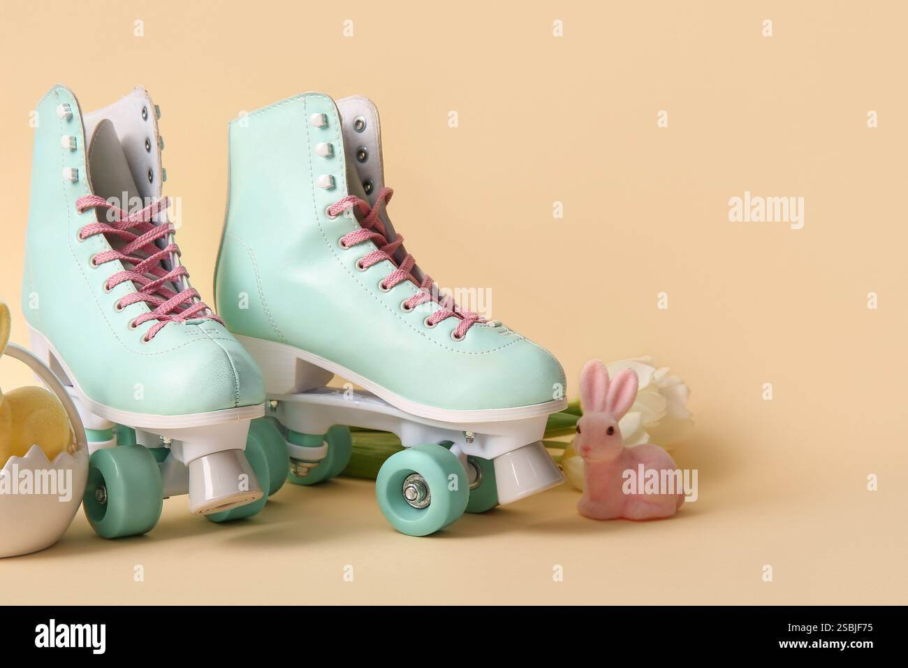 Vintage roller skates with toys bunny and beautiful tulips on yellow ...