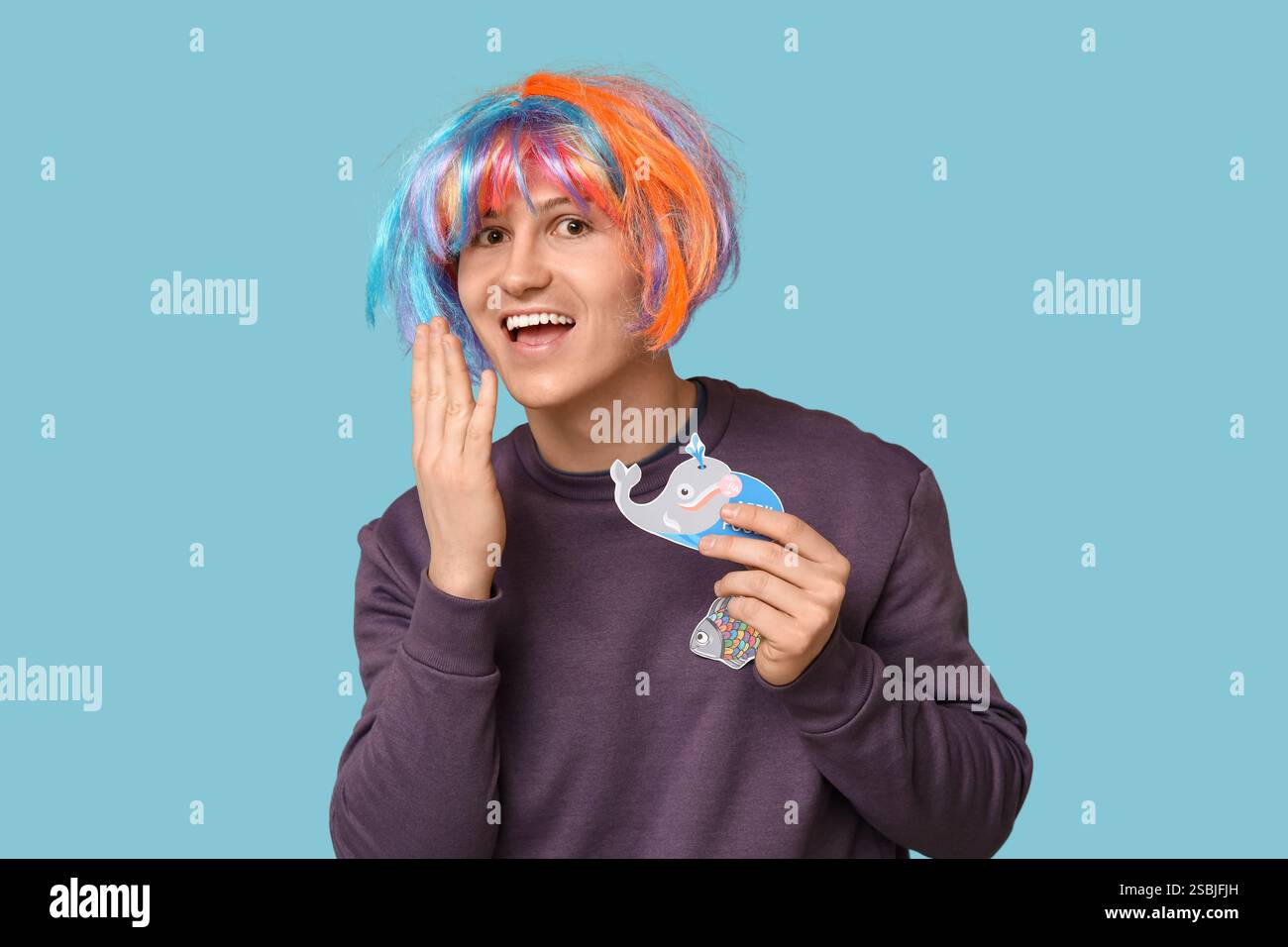 Handsome young shocked man in funny disguise with stickers on blue ...