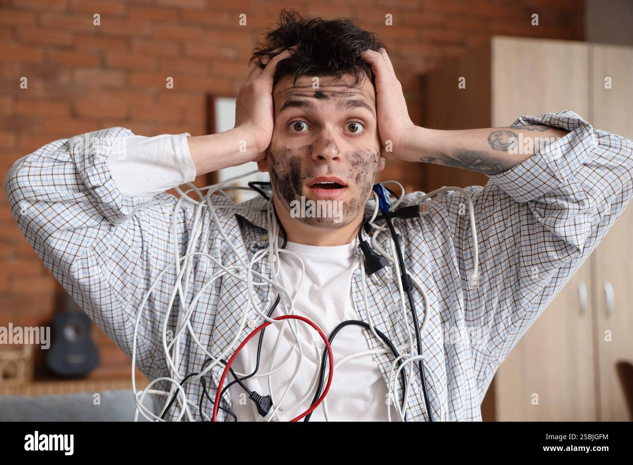 Electrocuted young man with burnt face and wires at home, closeup Stock ...
