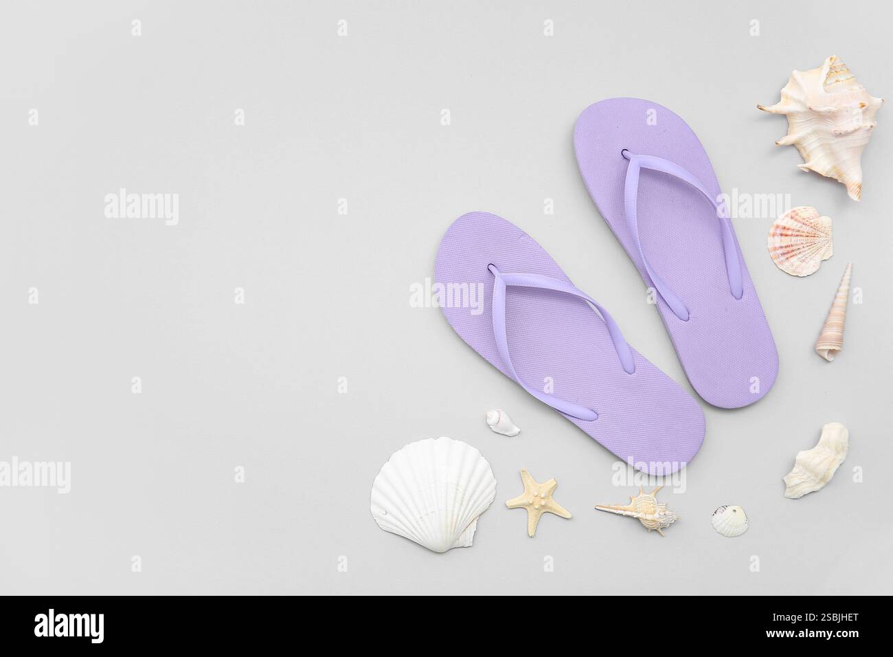 Stylish lilac flip-flops with seashells on white background Stock Photo ...