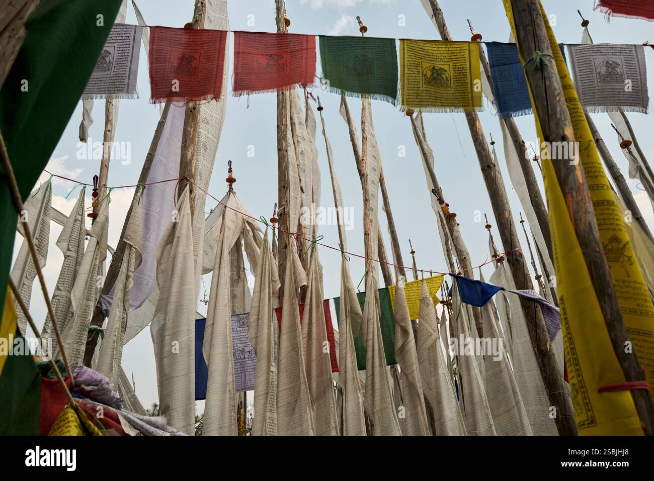 Wooden poles with prayer flags hi-res stock photography and images - Alamy