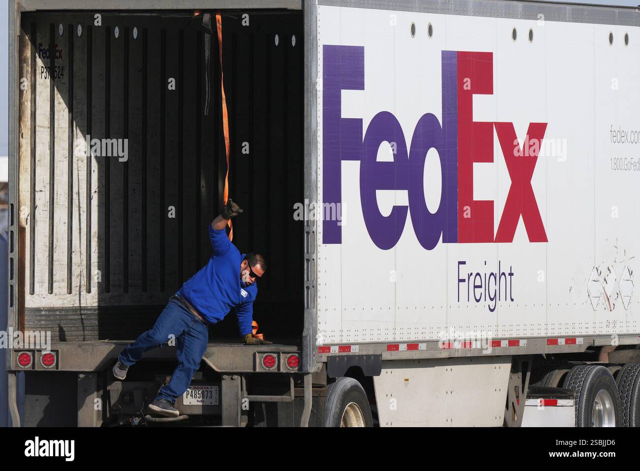 A driver opens his FedEx truck for inspection before it crosses into ...