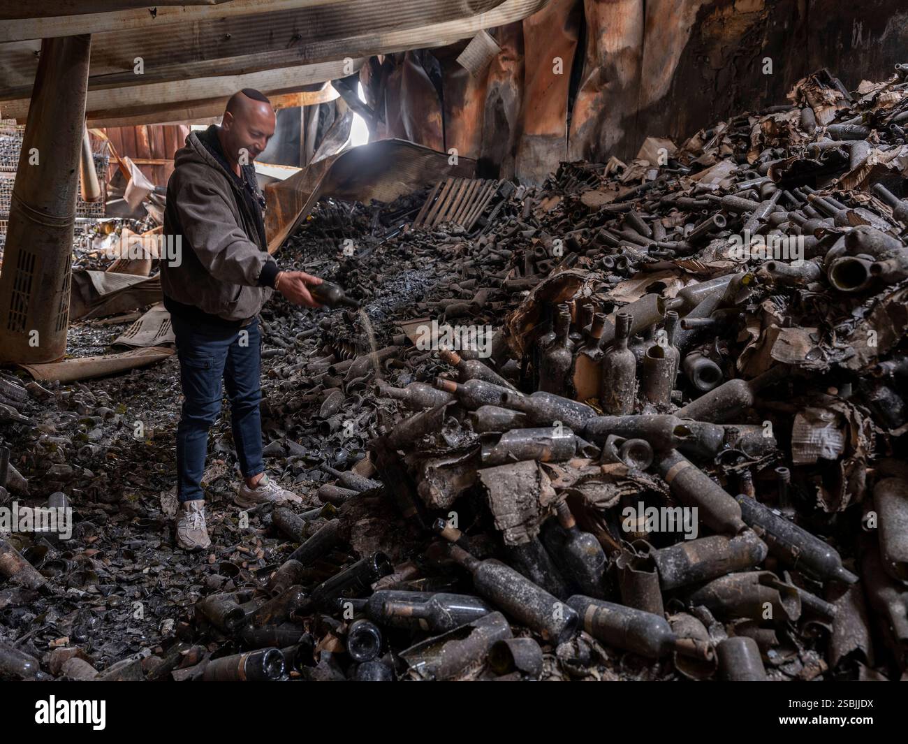 Meir Biton the manager of Avivim Winery pours out a bottle of wine in ...
