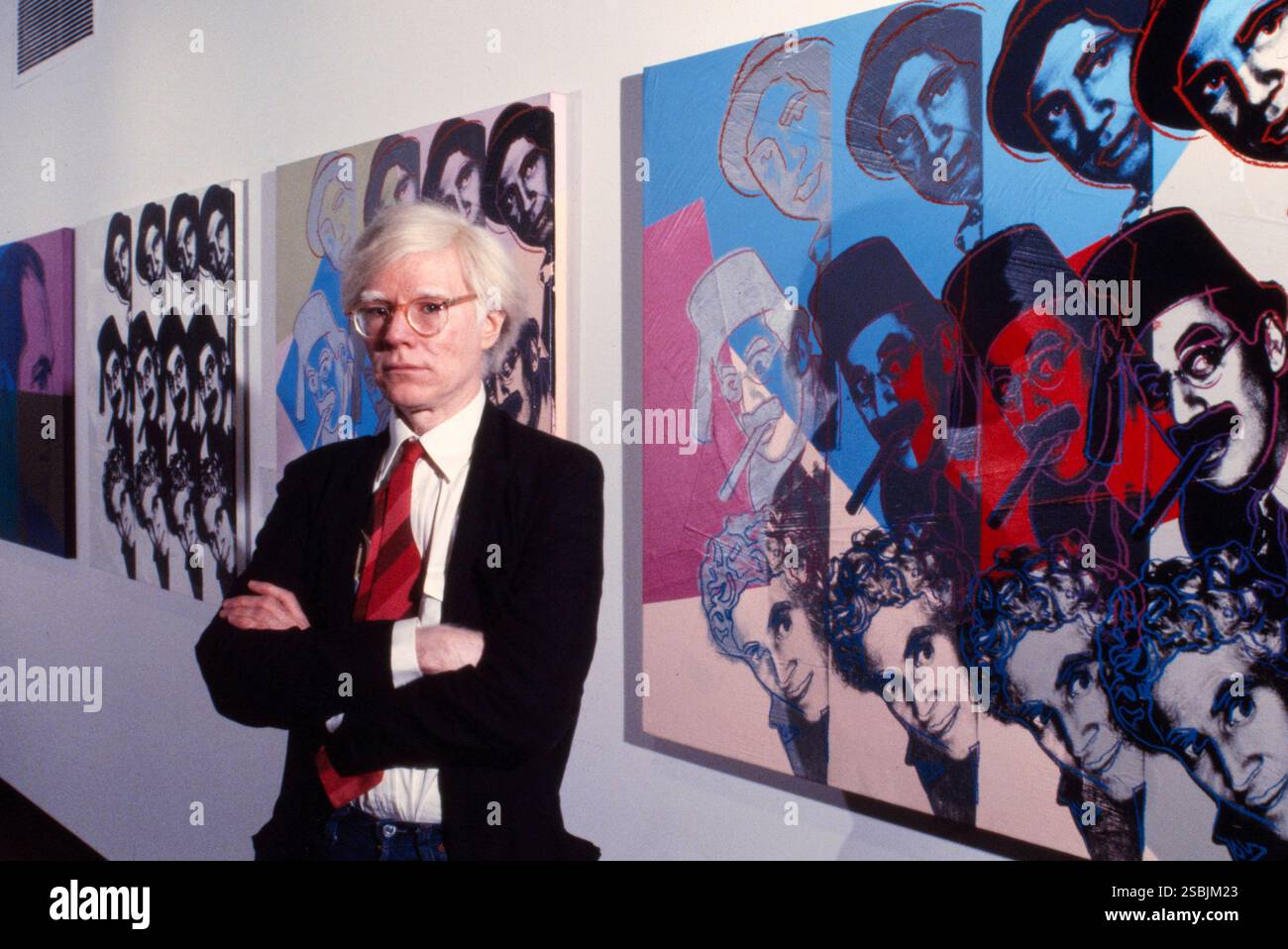 Andy Warhol (1928-1987) with his art at the Jewish Museum in New York City. Photographed by ...